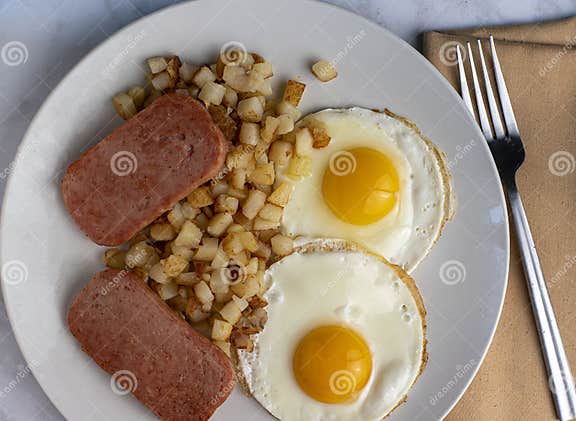 Two Fried Eggs with Fried Spam and Hash Browns Stock Photo - Image of ...