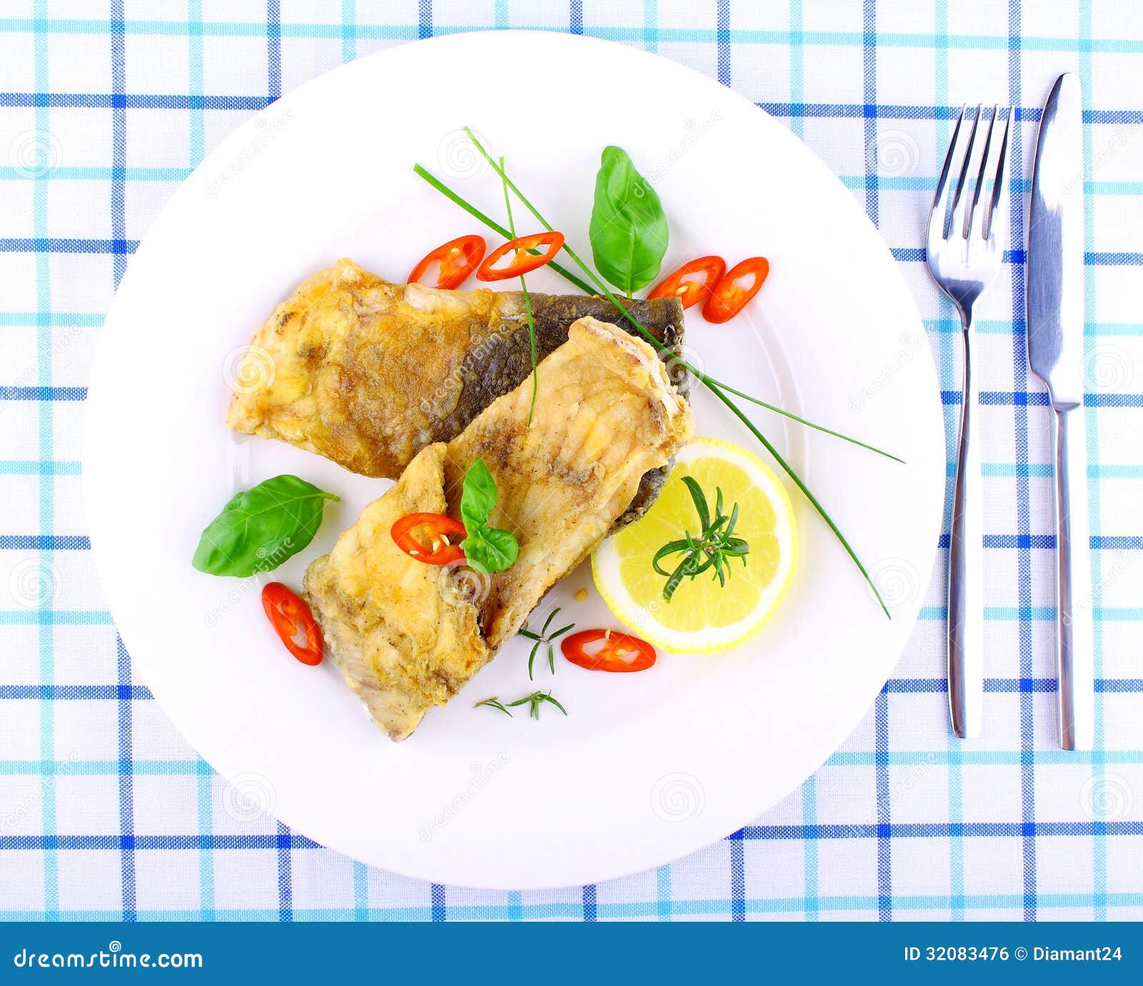 Two Fried Fish Fillets with Lemon Slice on White Plate Stock Photo ...