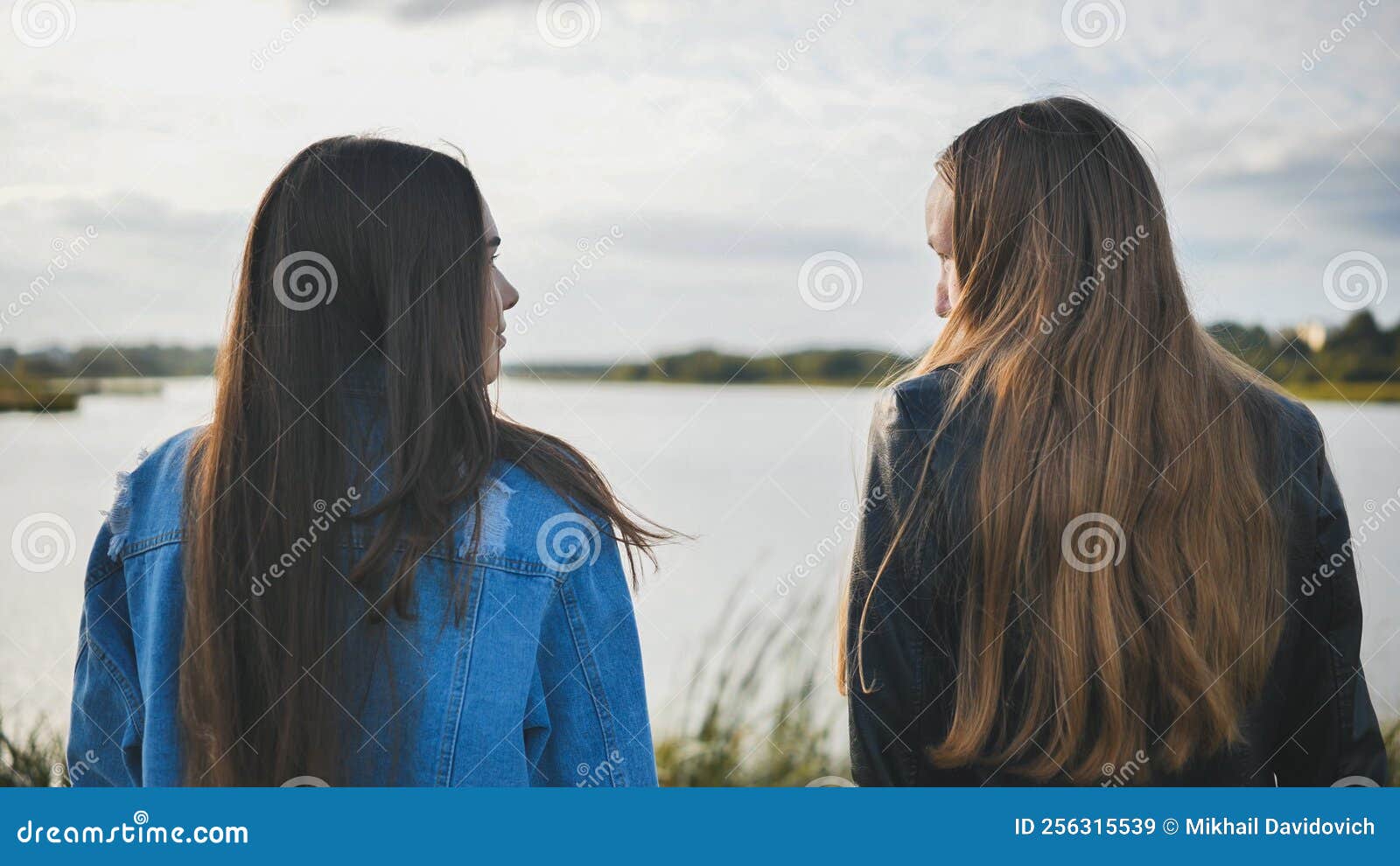 Two Friendly Friends Sit and Cuddle by the Lake. Stock Image - Image of ...