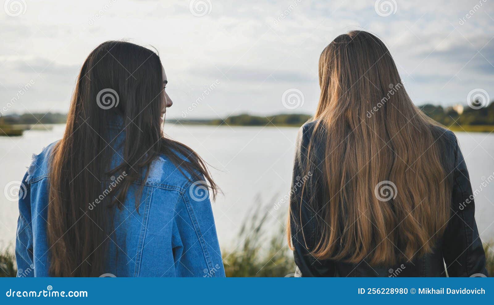 Two Friendly Friends Sit and Cuddle by the Lake. Stock Photo - Image of ...
