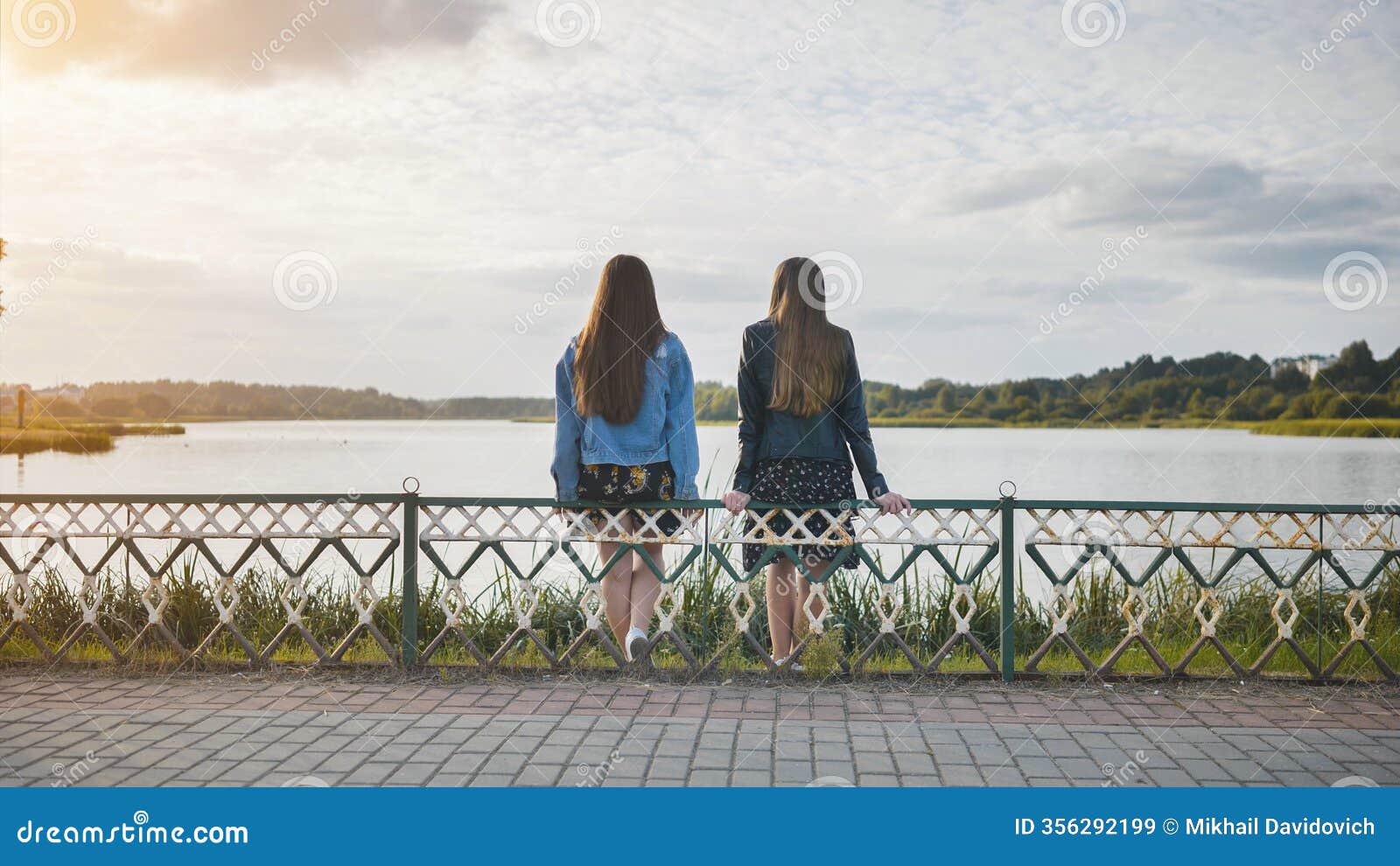 Two Friendly Friends Sit and Cuddle by the Lake. Stock Image - Image of ...