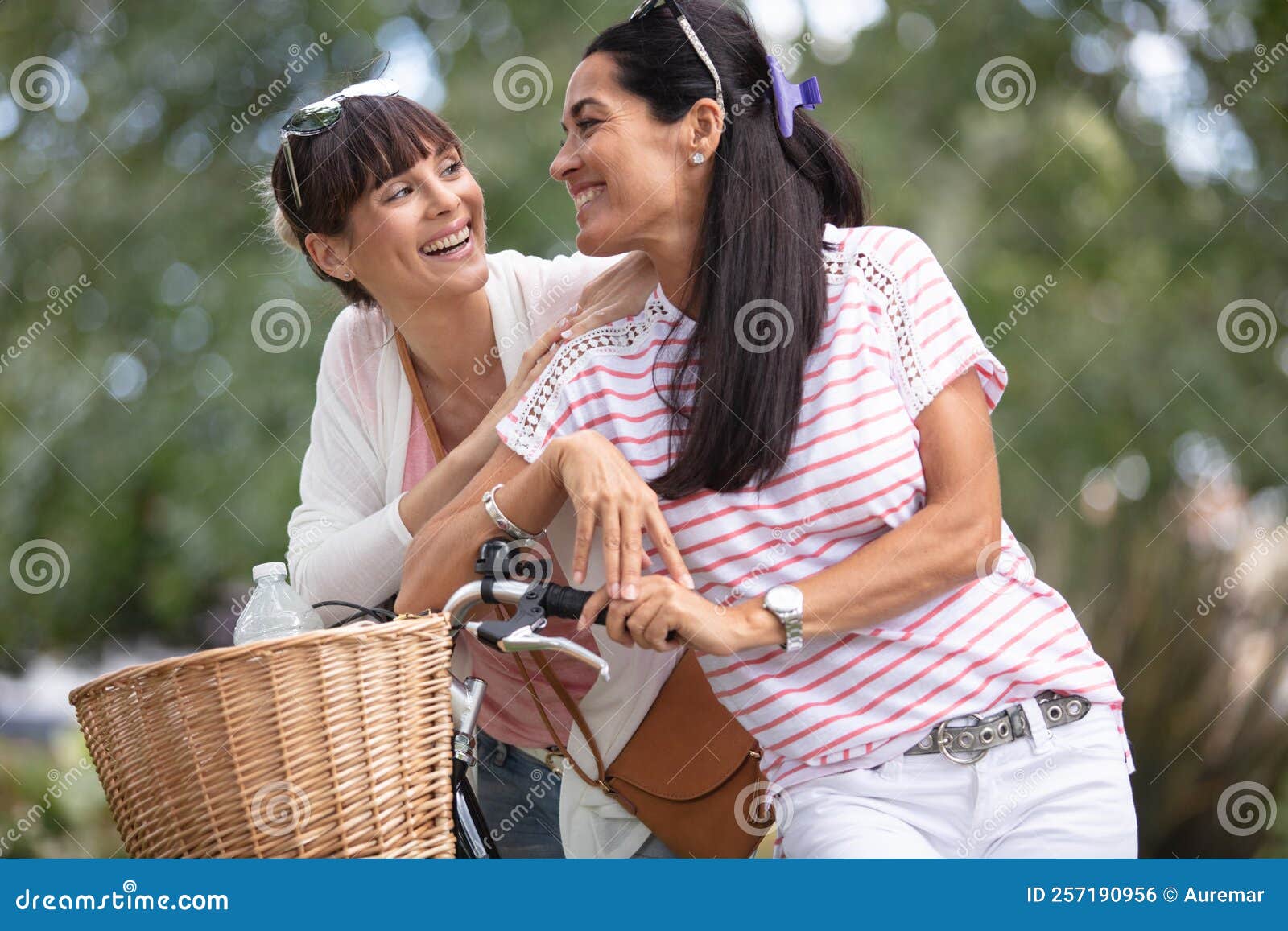 Two Friends on Bikes Outdoors Smiling Stock Photo - Image of looking ...