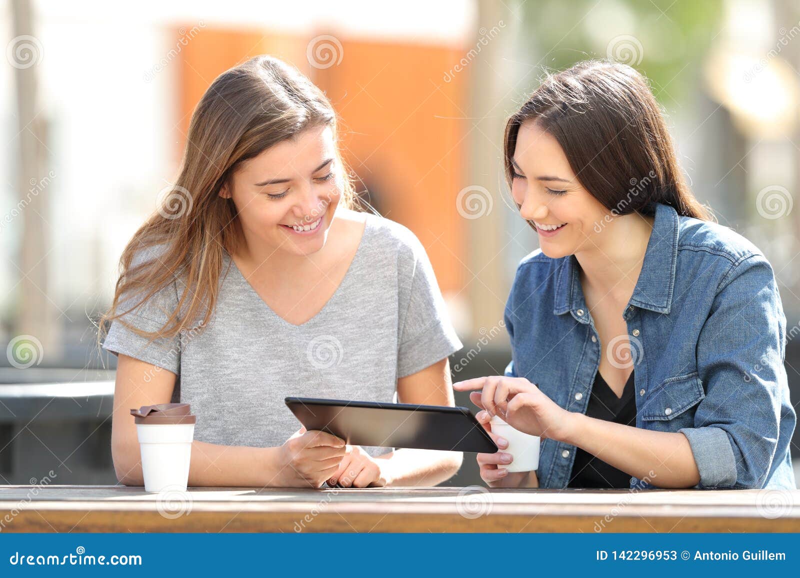 Two Friends Checking Tablet Content in a Park Stock Image - Image of ...