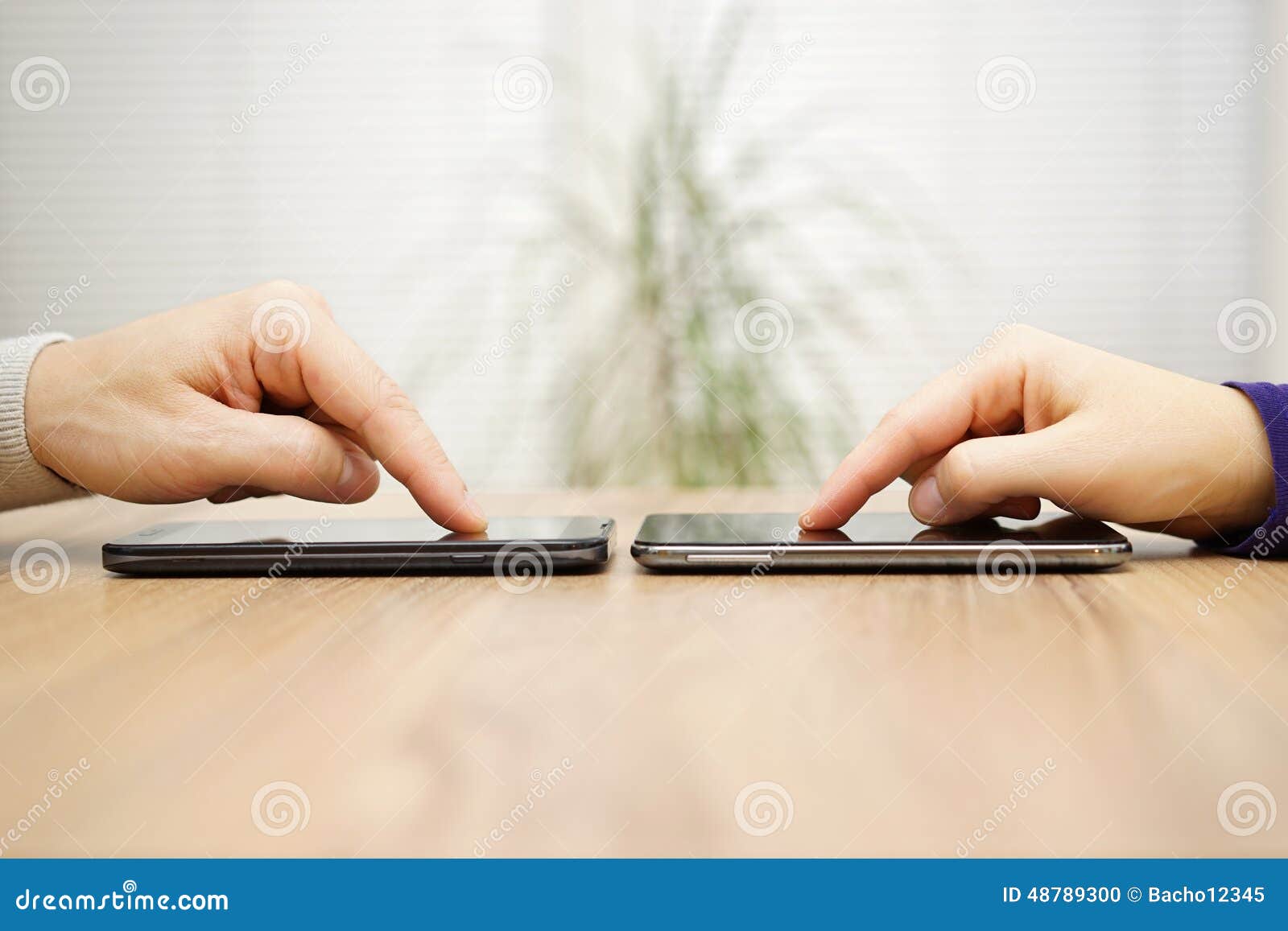 Two Friends are Connecting and Sharing Files Over Smart Phones Stock ...