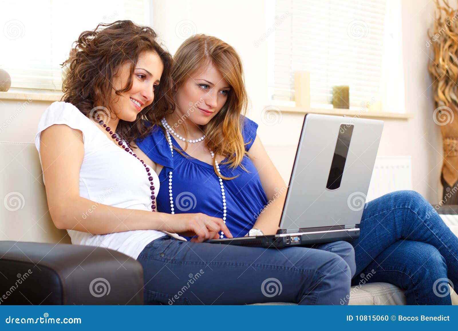 Two Friends on a Couch Using a Laptop Stock Photo - Image of portrait ...