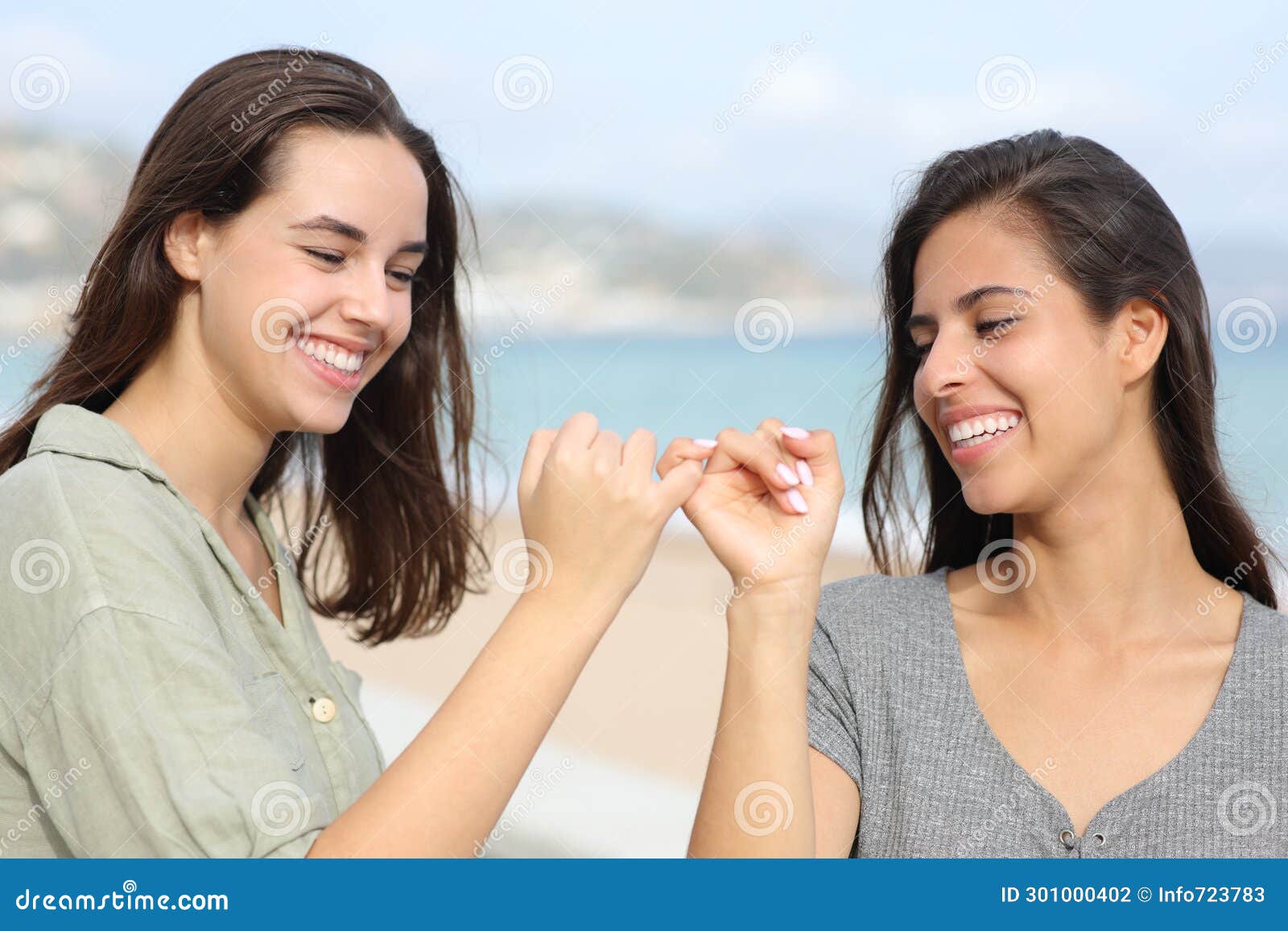 Two Friends Doing Pinky Promise on the Beach Stock Photo - Image of ...