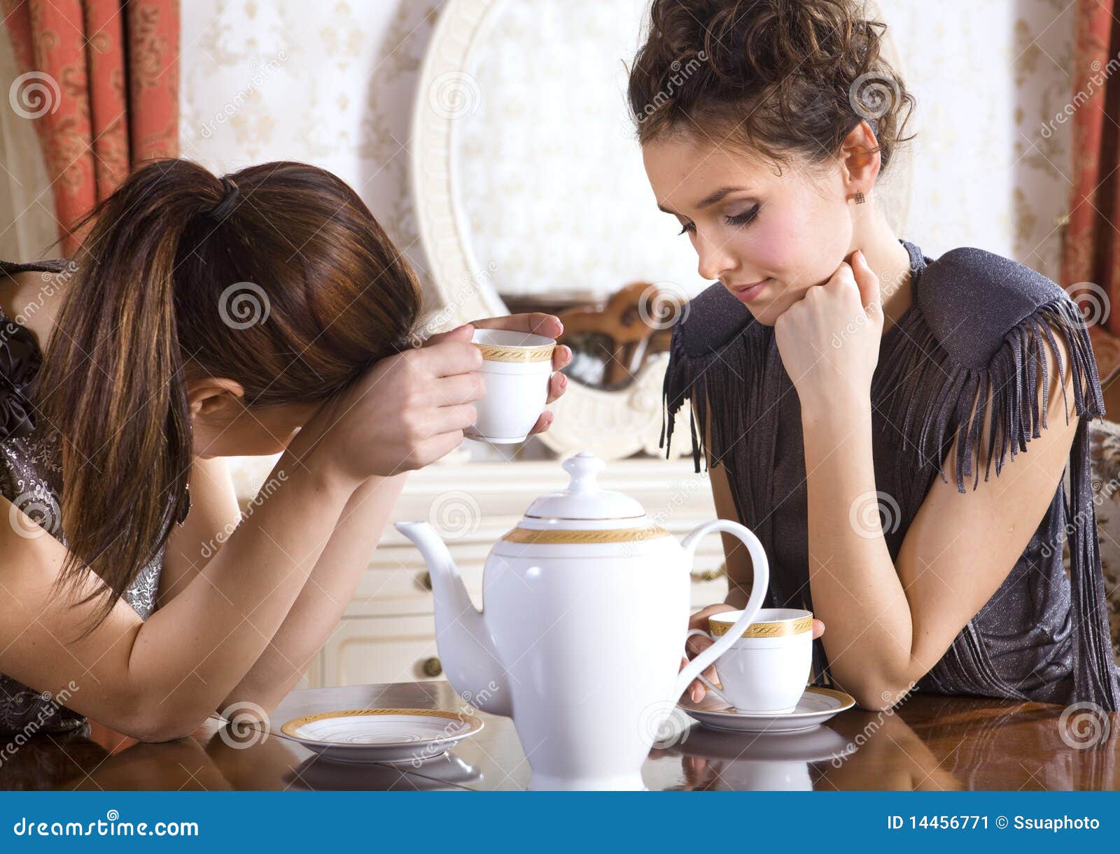 Two friends drink tea stock image. Image of brunette - 14456771