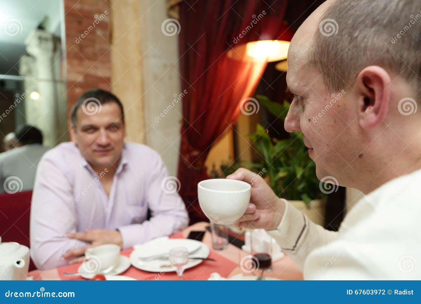 Two friends drinking tea stock photo. Image of couple - 67603972