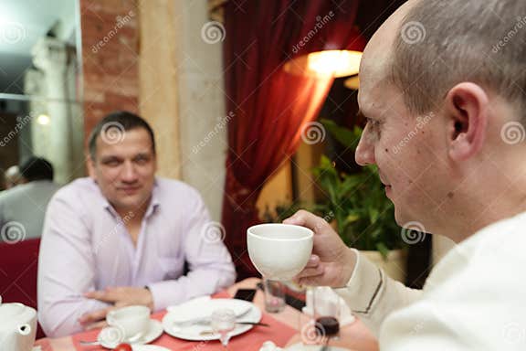 Two friends drinking tea stock photo. Image of couple - 67603972
