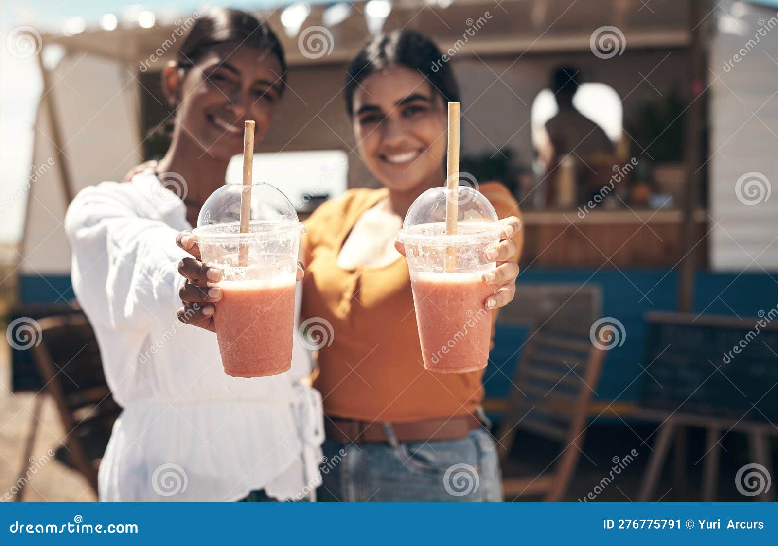 Two Friends Enjoying the Sun. Two Friends Enjoying Smoothies Together ...