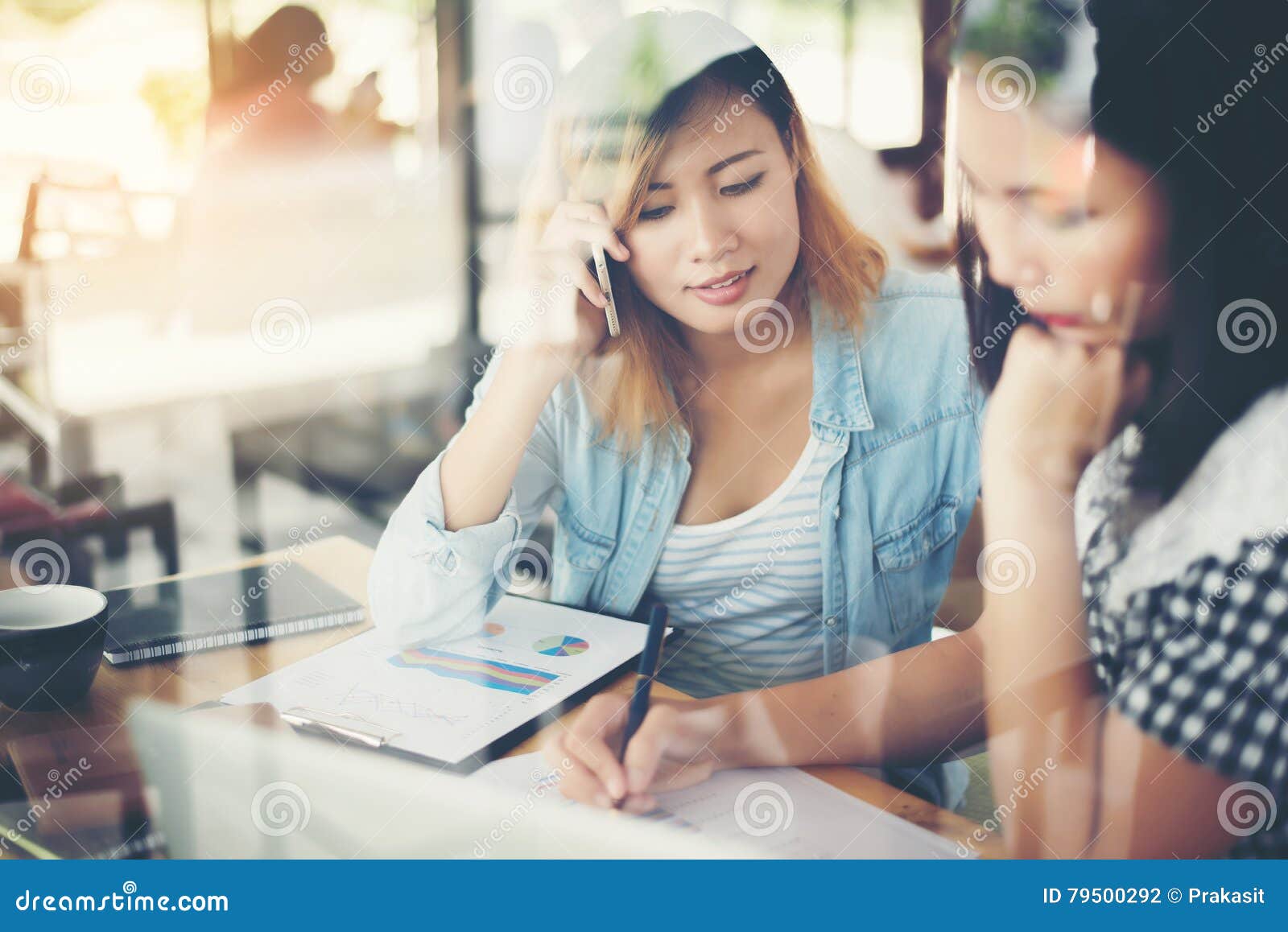 Two Friends Enjoying Working Together with Window Reflection in Stock ...