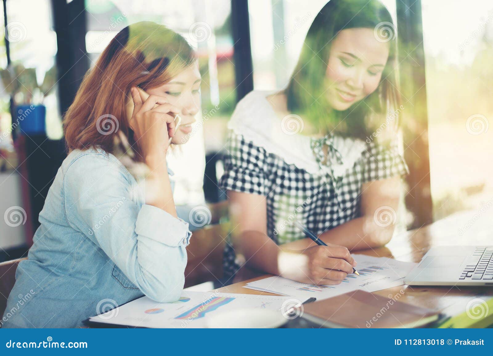Two Friends Enjoying Working Together with Window Reflection in Stock ...