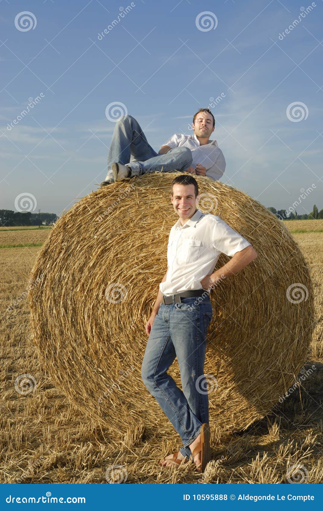 Two Friends in a Field with Straw Bales Stock Photo - Image of sitting ...