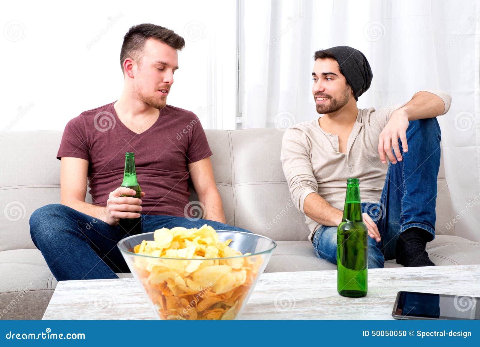 Two Friends Having a Conversation in the Living Room Stock Photo ...