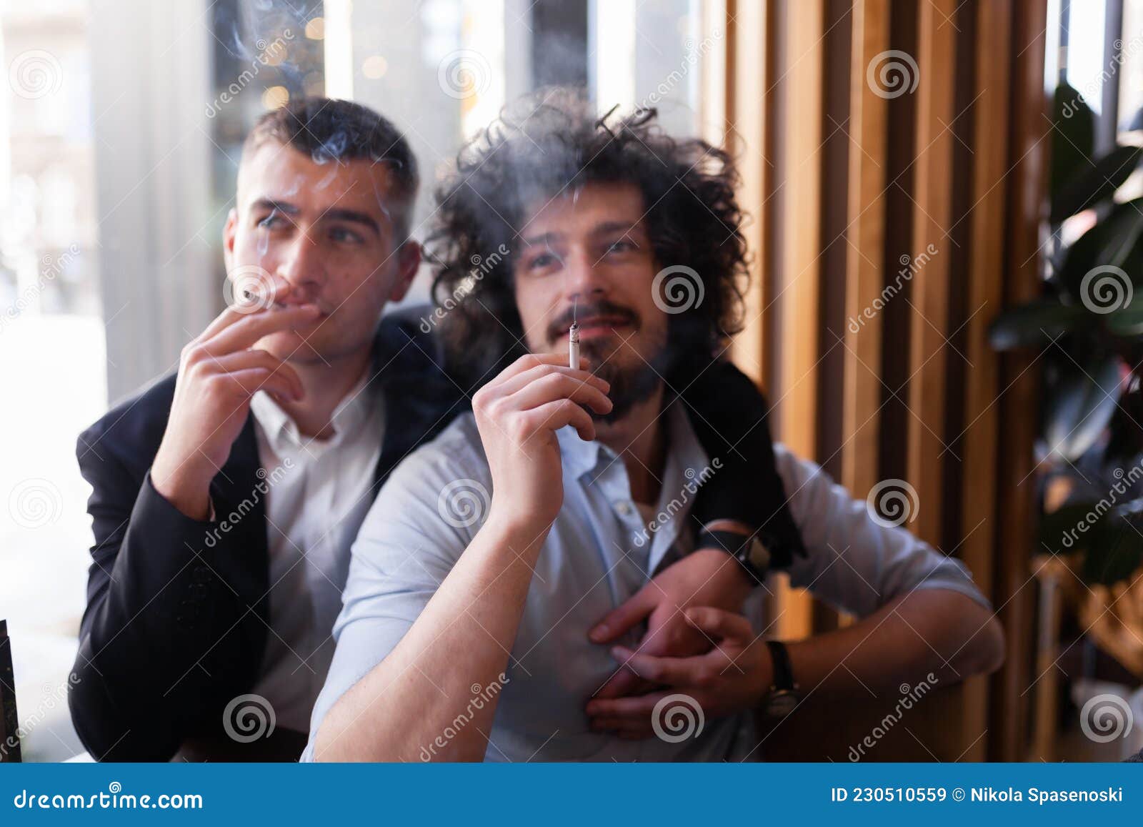Two Friends Hugging in a Cafe, Having a Cigarette Stock Image - Image ...