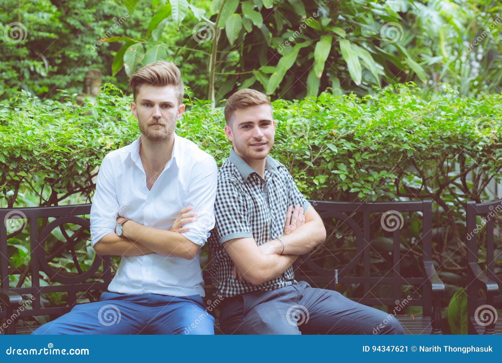 Two Friends Men Talking Sitting in a Garden. Stock Image - Image of ...