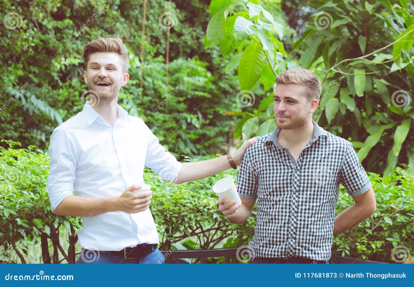 Two Friends Men Talking Standing in a Garden. Stock Image - Image of ...