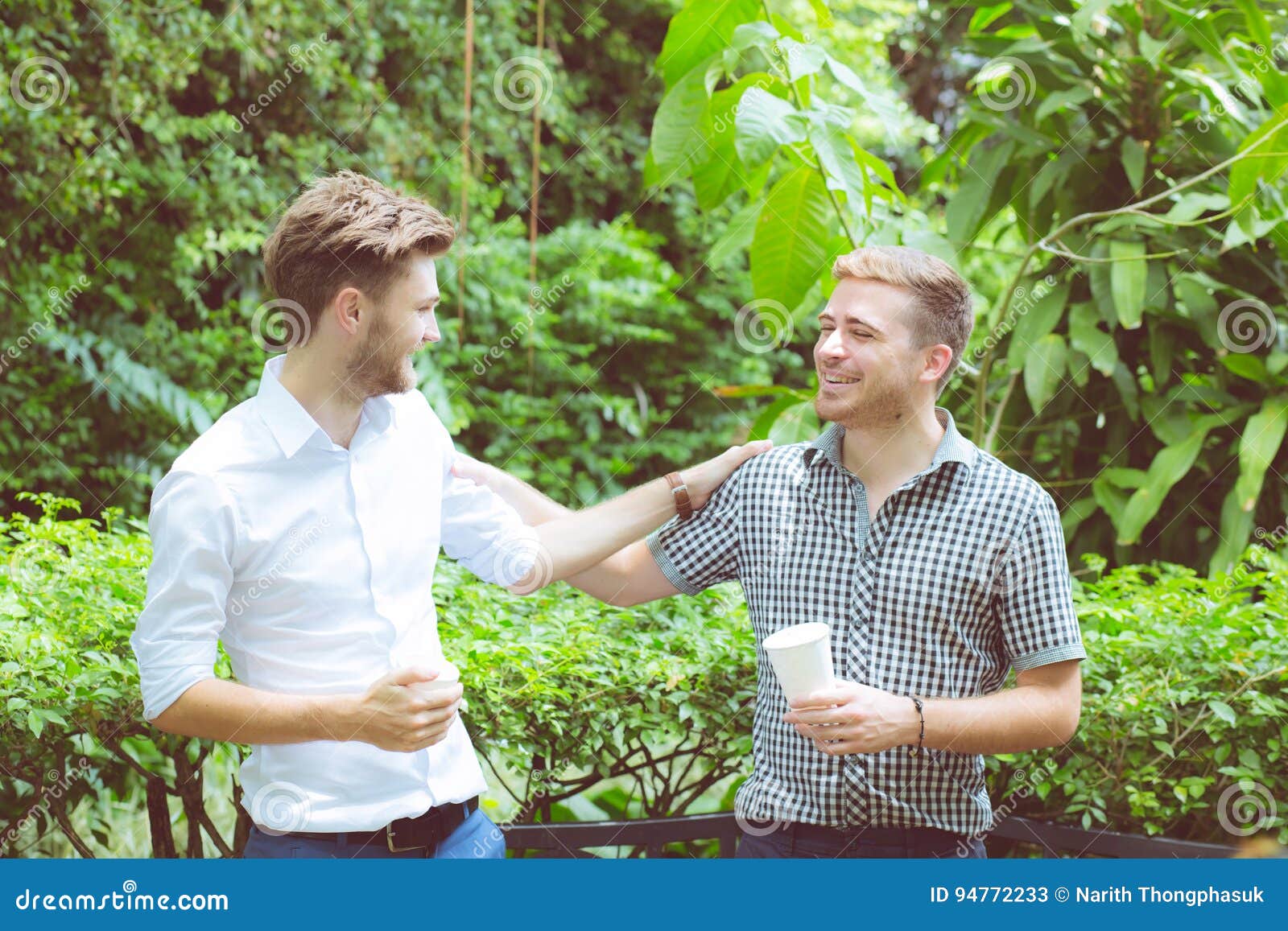 Two Friends Men Talking Standing in a Garden. Stock Image - Image of ...