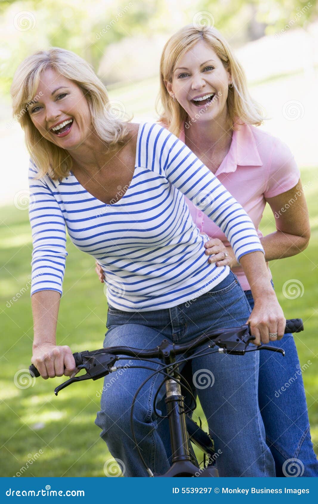 Two Friends on One Bike Outdoors Smiling Stock Image - Image of ...