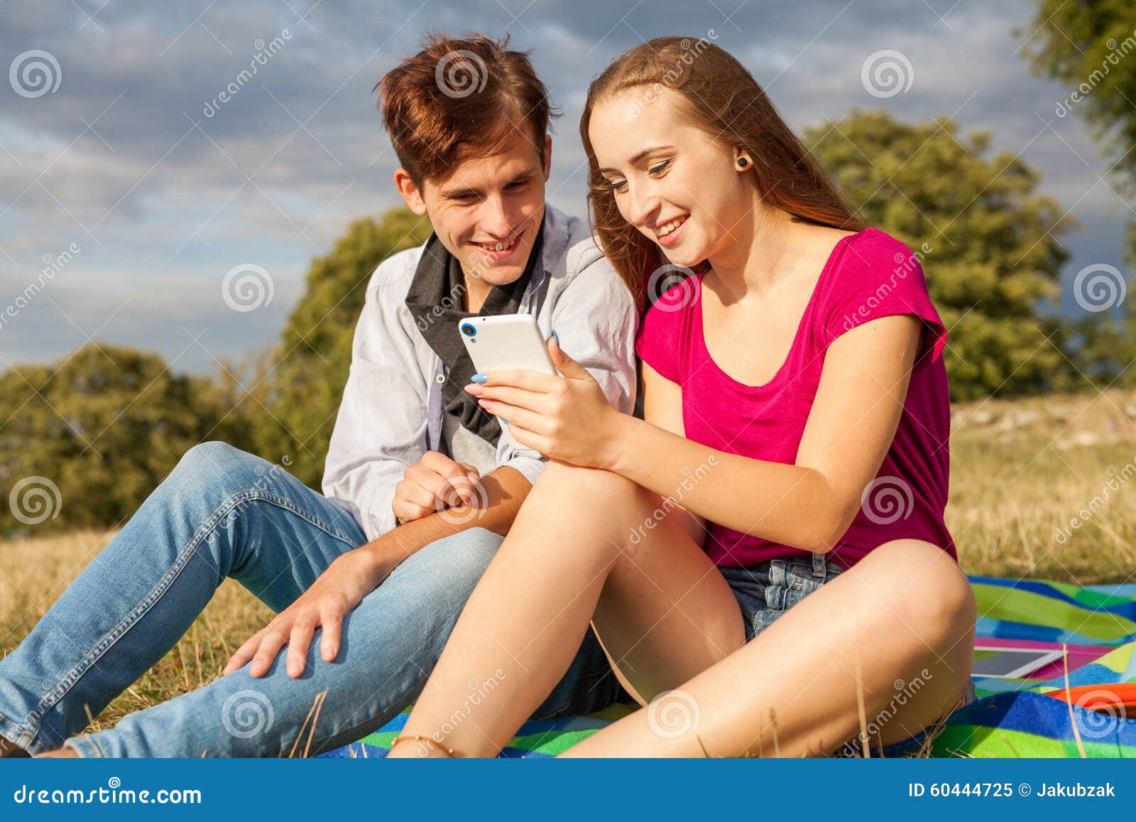 Two Friends in a Park with Mobile Phone Stock Image - Image of girl ...