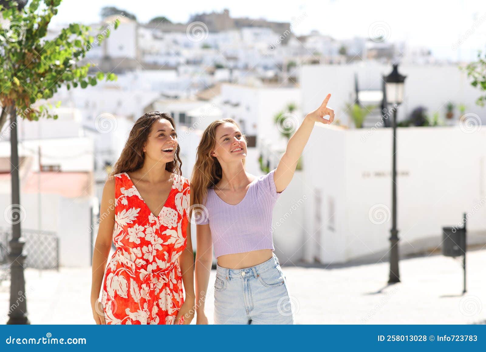 Two Friends Pointing in a Town Street on Summer Stock Photo - Image of ...
