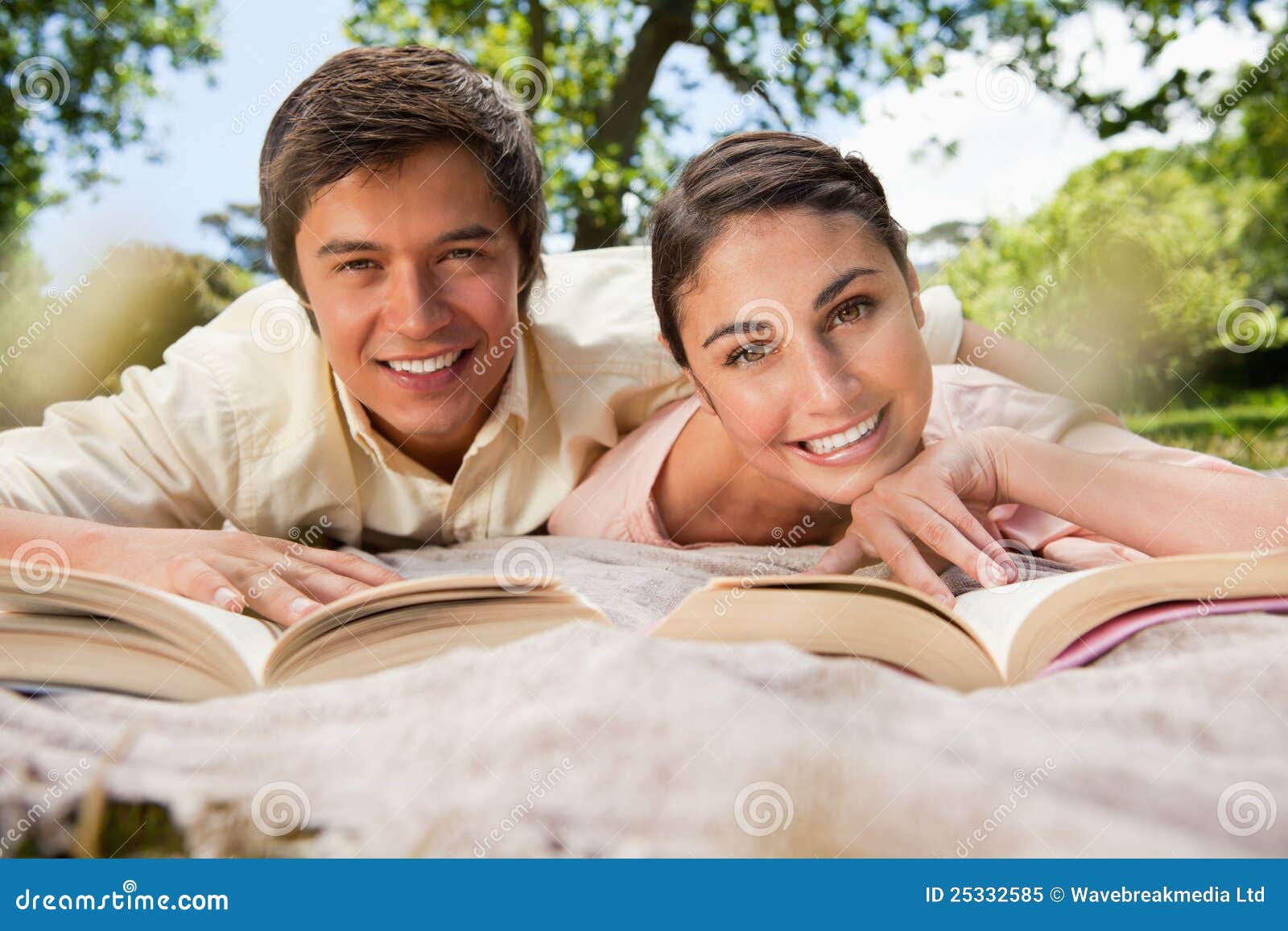 Two Friends Reading Books while Lying on a Blanket Stock Image - Image ...
