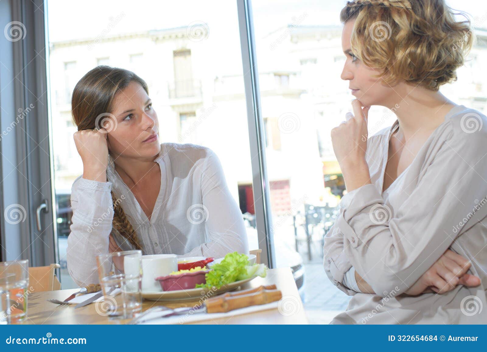 Two Friends with Serious Expression Talking at Restaurant Stock Photo ...