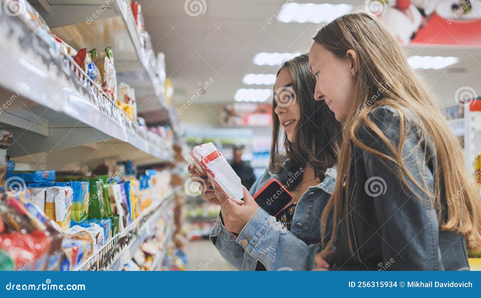 Two Friends are in the Shop Buying Biscuits and Sweets. Stock Photo ...