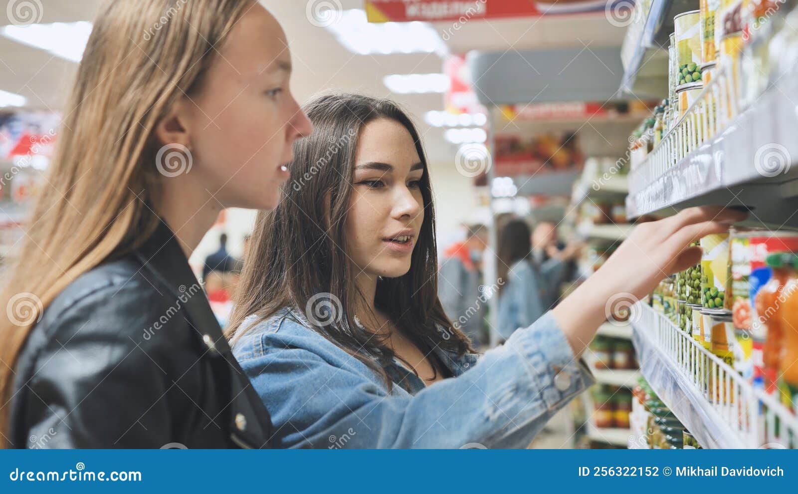 Two Friends are in the Shop Buying Biscuits and Sweets. Stock Photo ...