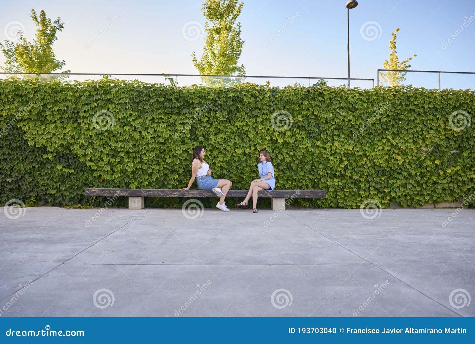 Two Friends Sitting on a Bench. Stock Photo - Image of denim, blonde ...