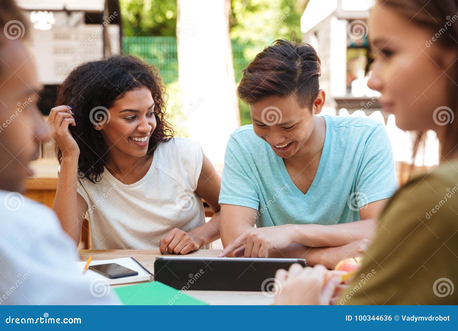 Two Friends Sitting Outdoors by the Table Stock Photo - Image of group ...