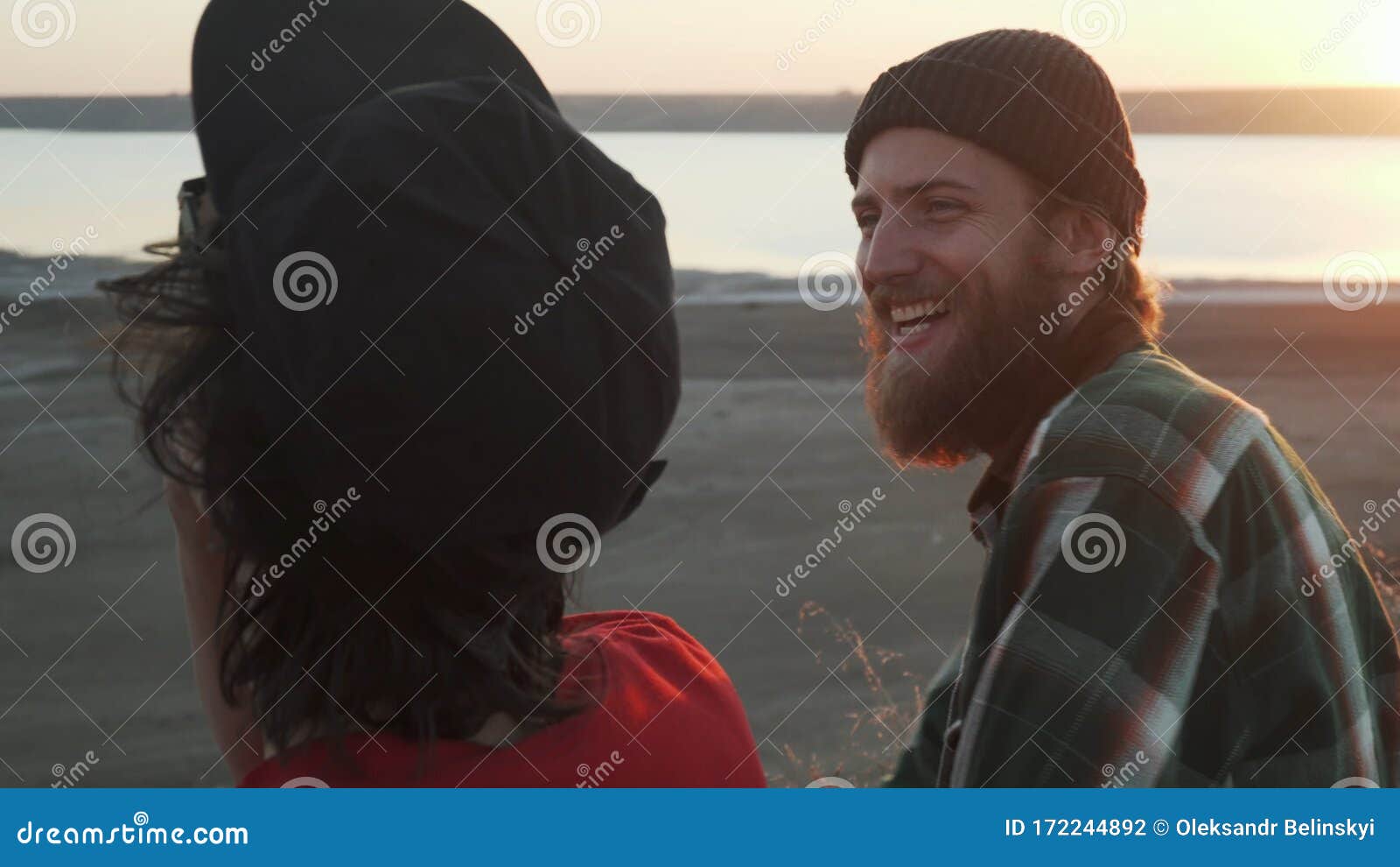 Two Friends Smoking Joint with Weed at Seashore at Sunset Stock Photo ...