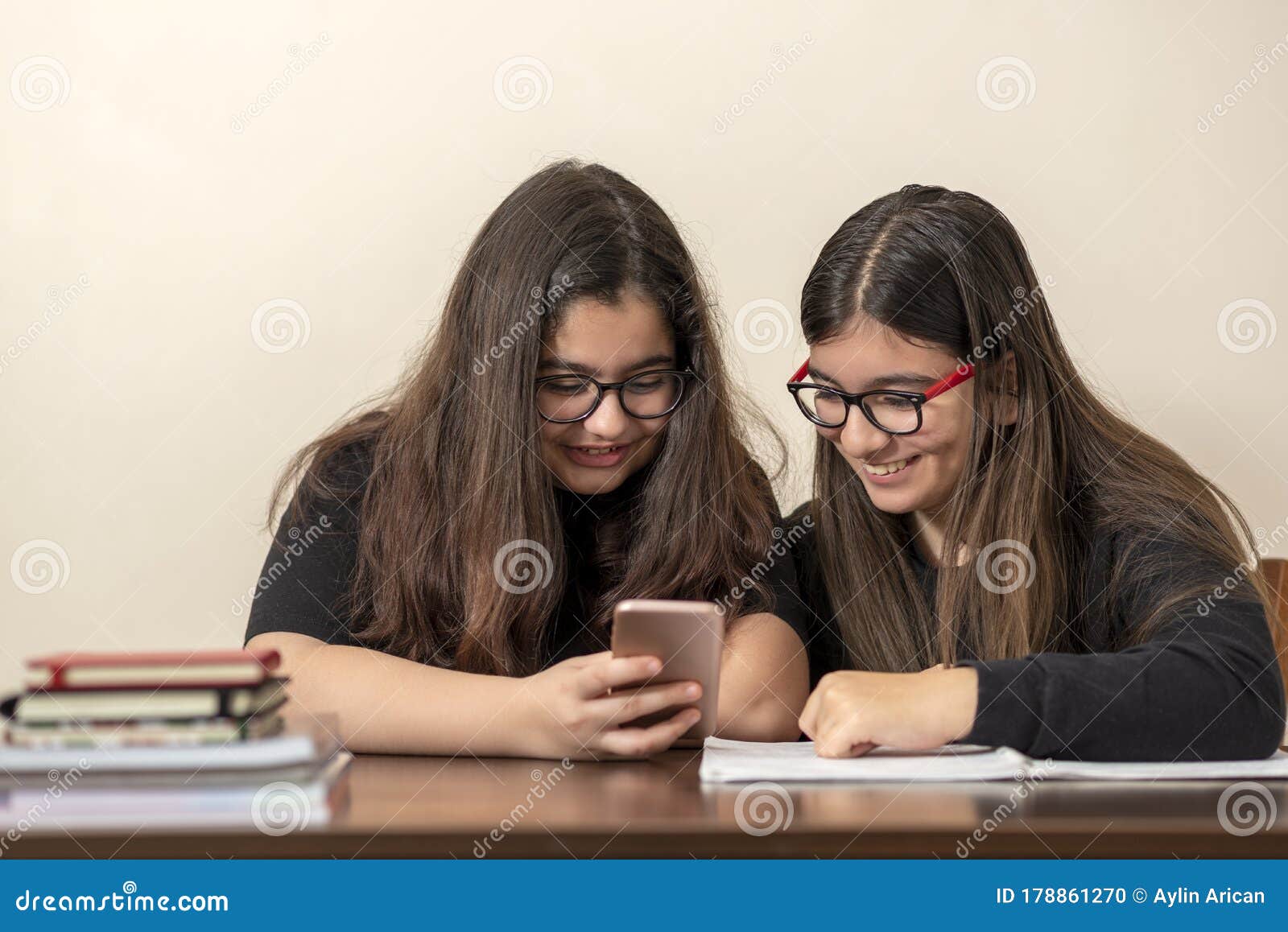 Two Friends Take a Break from Homework and Play with a Mobile Phone ...
