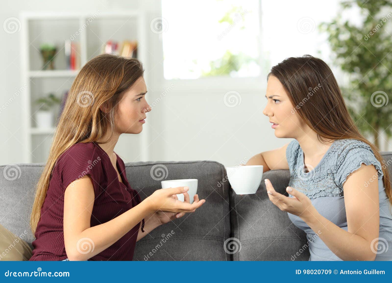 Two Friends Talking Seriously at Home Stock Image - Image of ...