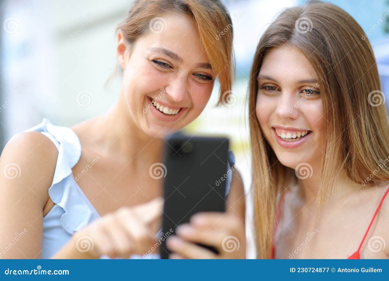 Two Friends Using Smart Phone in the Street Stock Image - Image of game ...