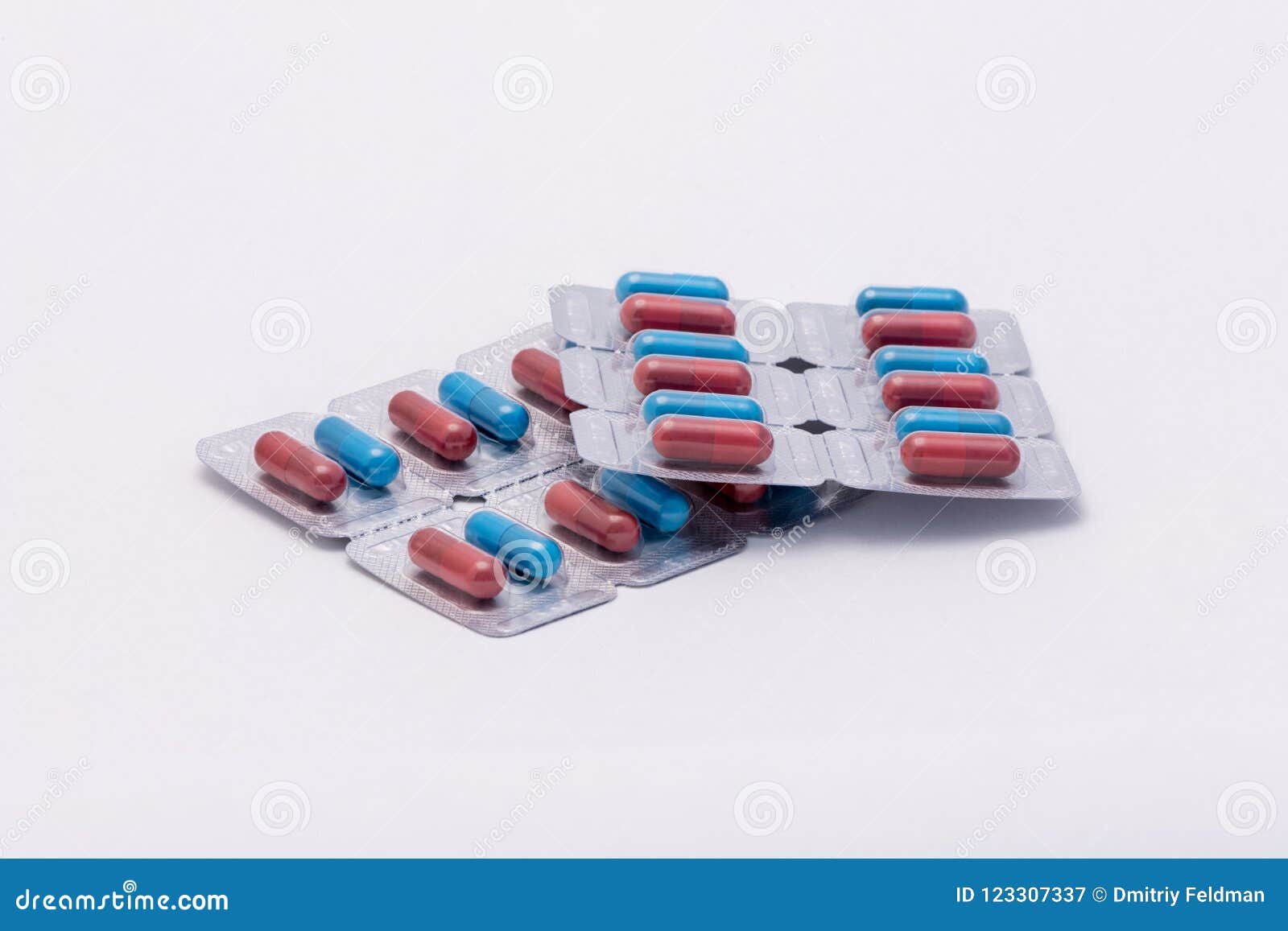 Two Full Sealed Packages with Blue and Brown Rectangular Pills Lie on a ...