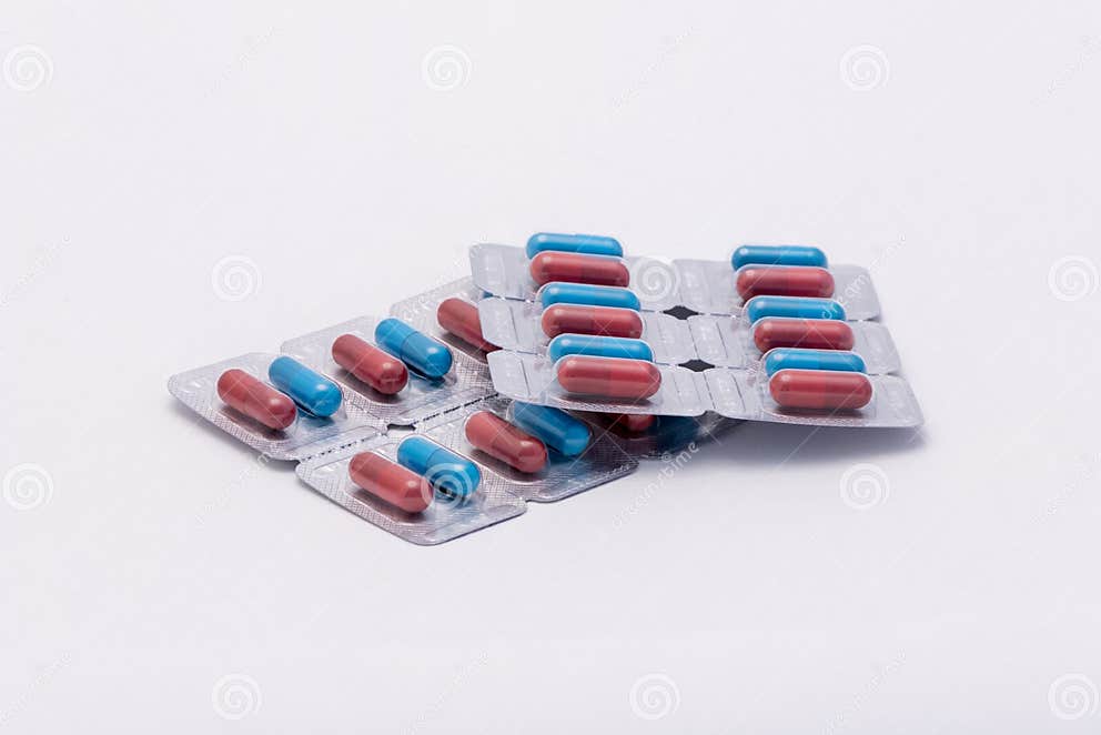 Two Full Sealed Packages with Blue and Brown Rectangular Pills Lie on a ...