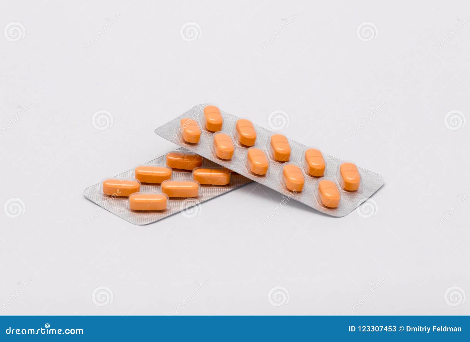 Two Full Sealed Packages with Orange Rectangular Pills Lie on a White ...