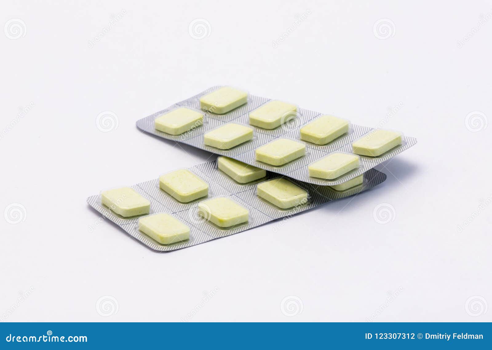 Two Full Sealed Packages with White Rectangular Tablets Lie on a White ...