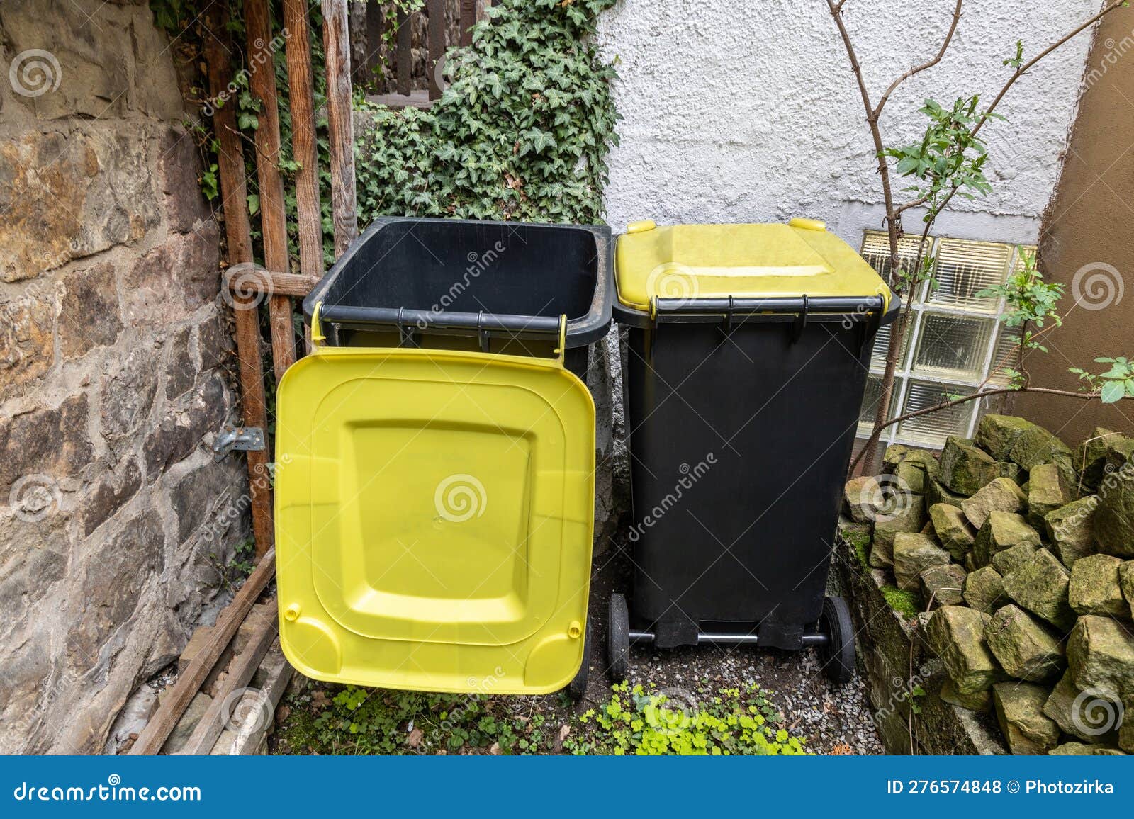 Two Garbage Cans for Plastic are in the Yard Stock Photo - Image of ...