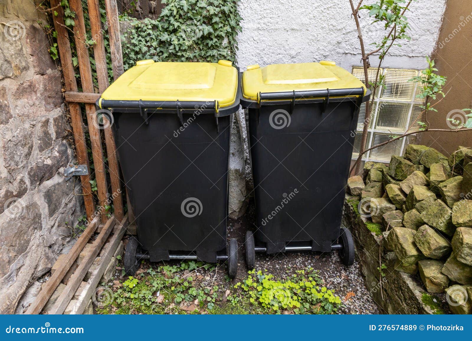 Two Garbage Cans for Plastic are in the Yard Stock Image - Image of ...