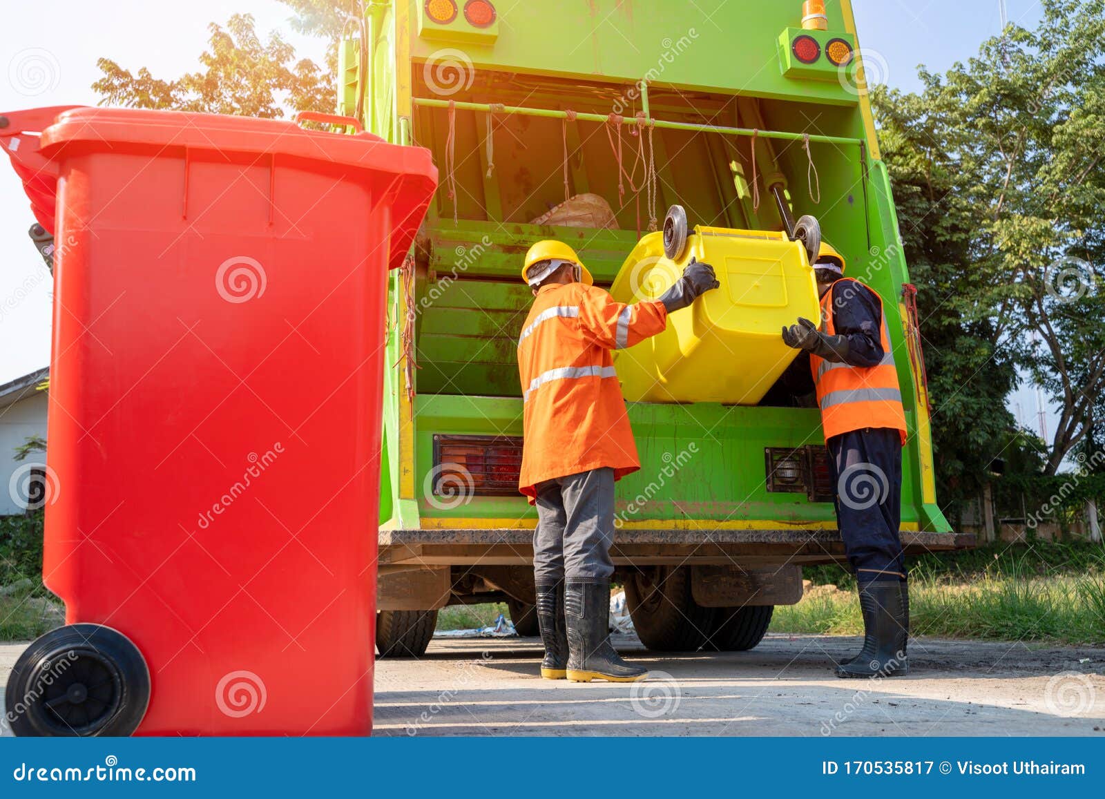 Two Garbage Men Working Together on Emptying Dustbins for Trash Removal ... Two Garbage Men Working Together on Emptying Dustbins for Trash Removal ...