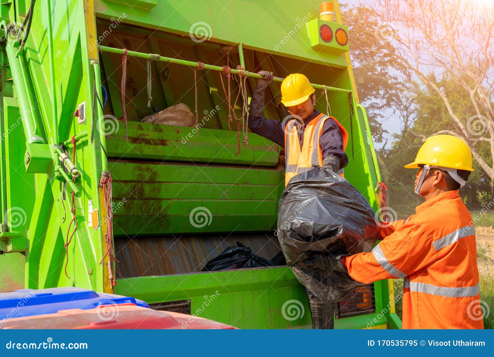 Two Garbage Men Working Together on Emptying Dustbins for Trash Removal ... Two Garbage Men Working Together on Emptying Dustbins for Trash Removal ...