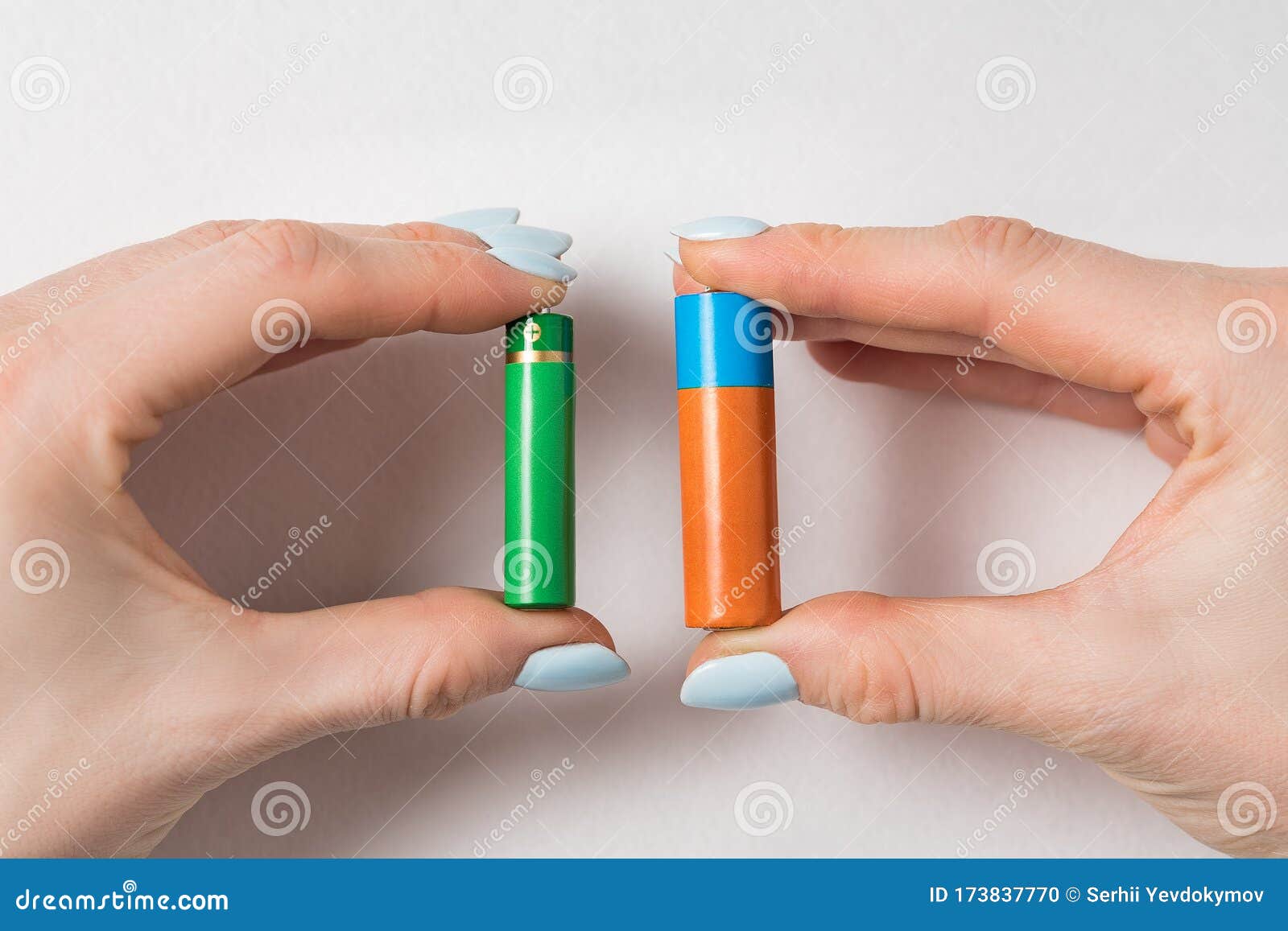 Two Generic AA and AAA Batteries in Hands. Generic Accumulators on ...