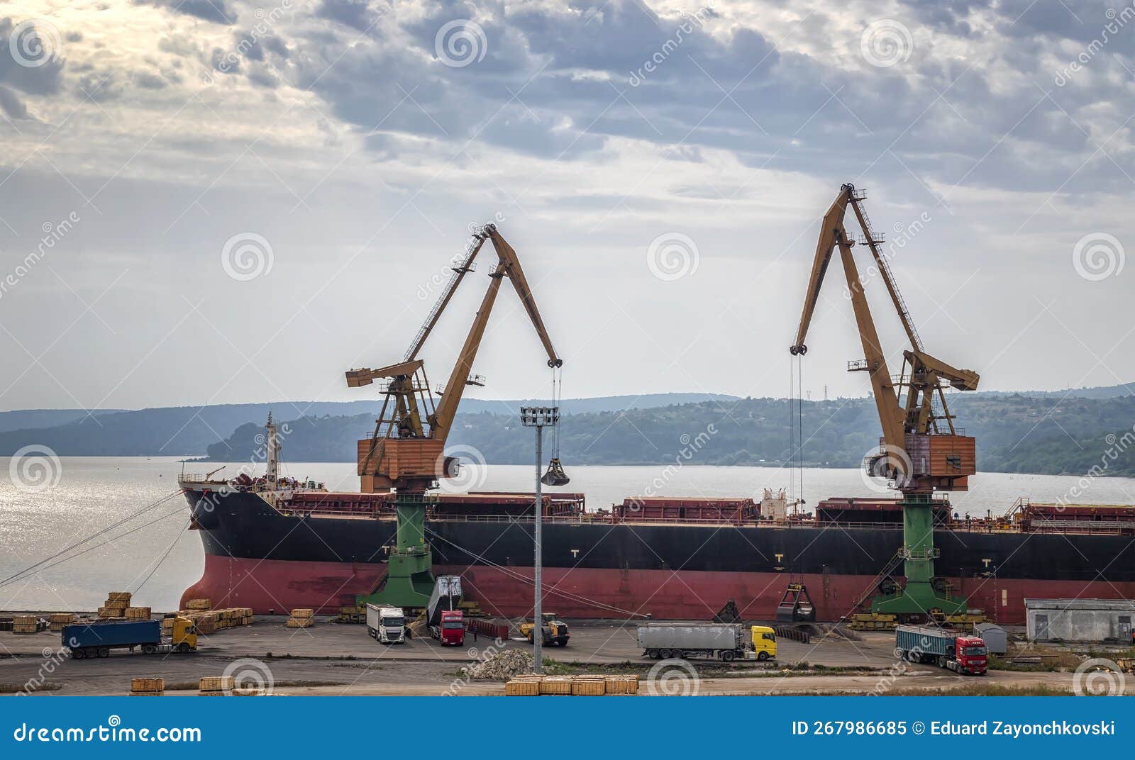 Two Giant Port Cranes Load Grain from Cargo Ships. Stock Image - Image ...