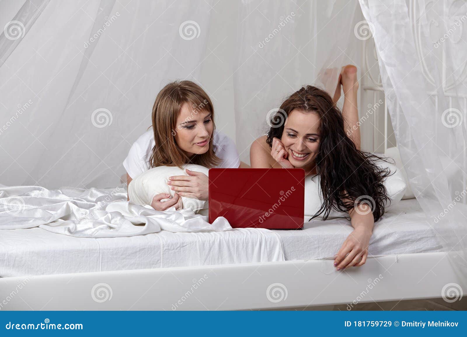 Two girlfriend with laptop stock image. Image of lying - 181759729