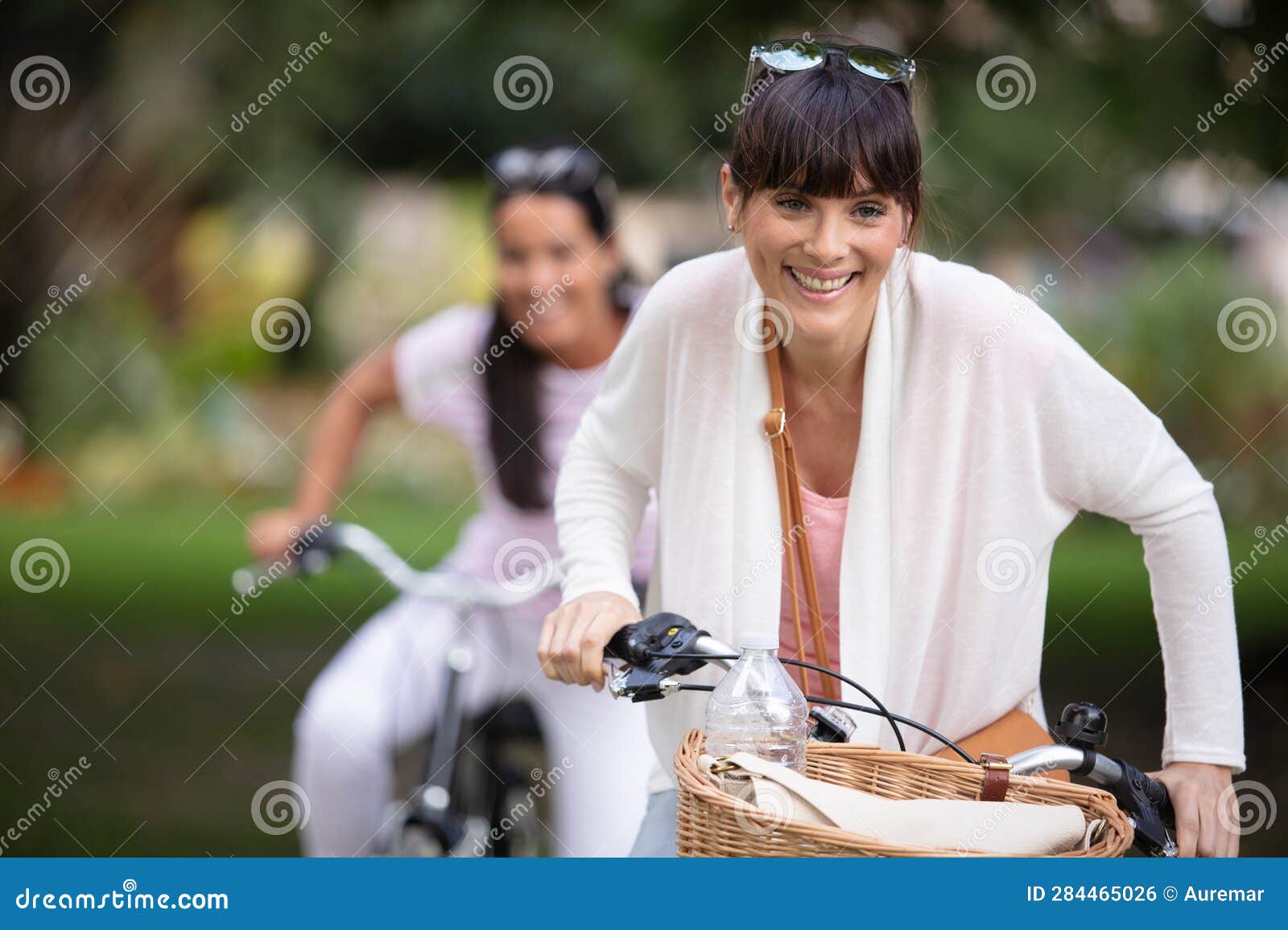 Two Girlfriends on Bikes Talking and Laughing Stock Photo - Image of ...
