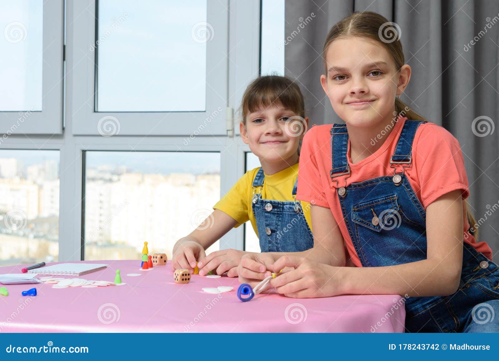 Two Girlfriends Play Board Games for Children and Looked at the Frame ...