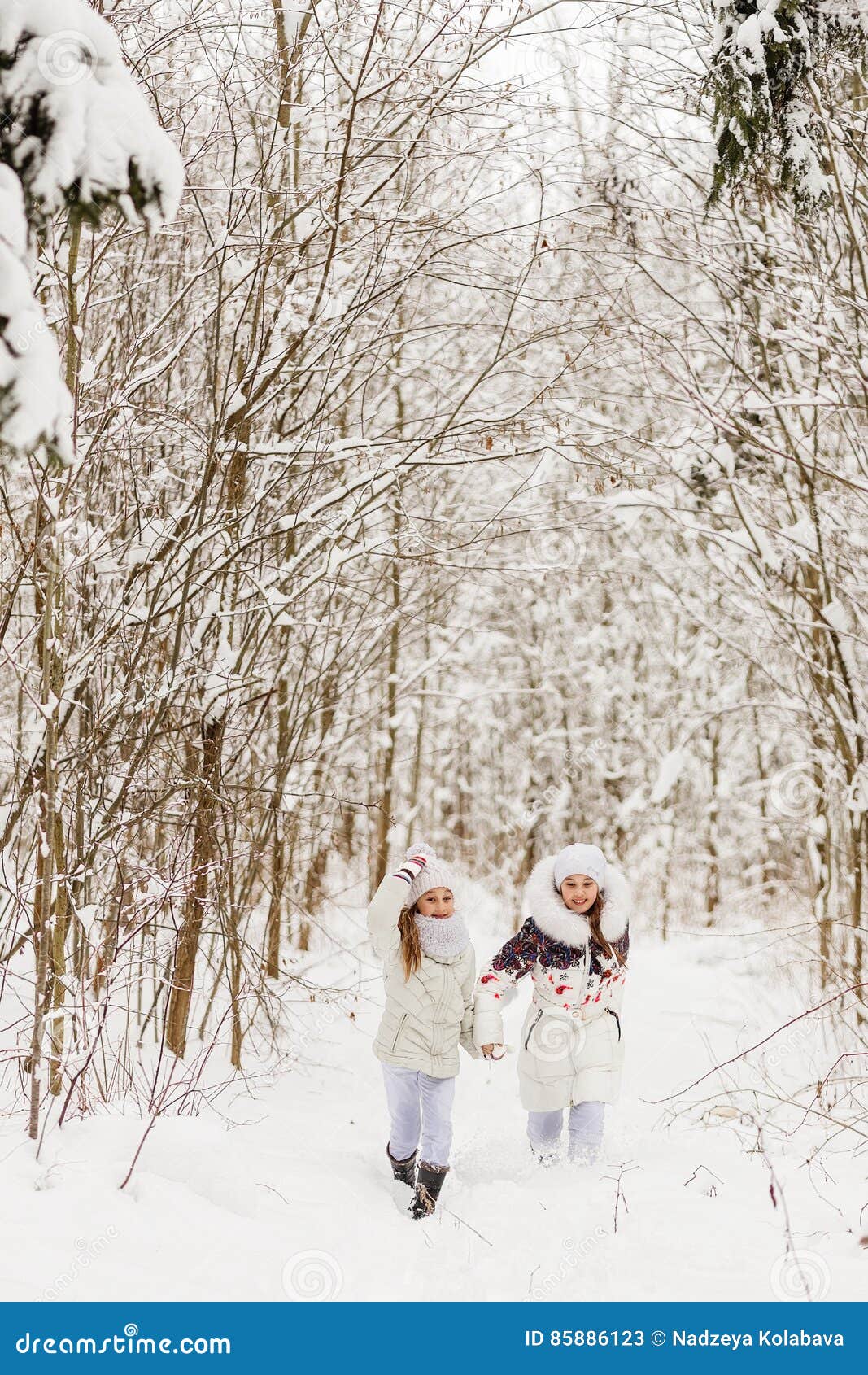 Two Girlfriends Playing in a Winter Forest. Stock Image - Image of jump ...