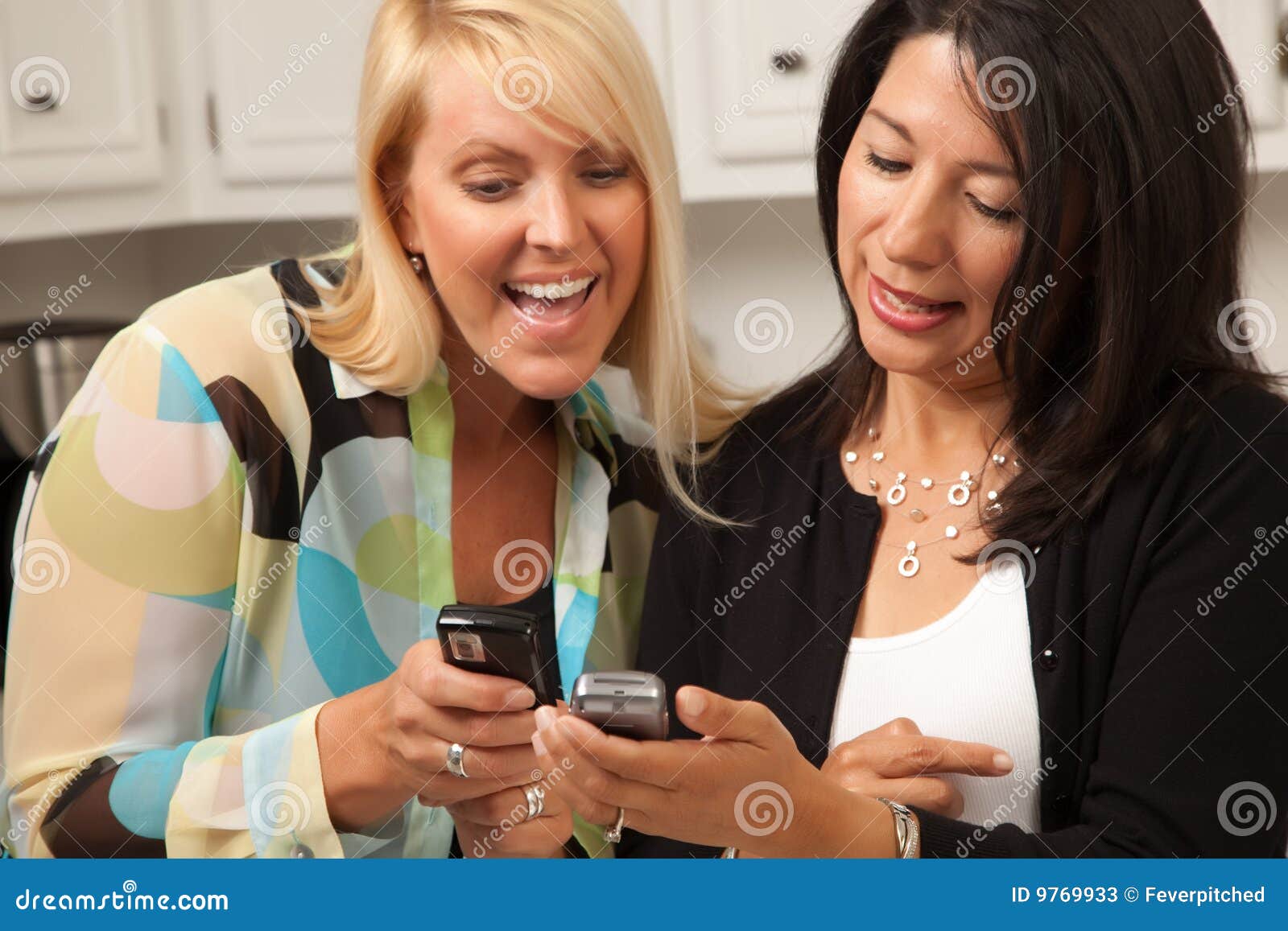 Two Girlfriends Sharing with Their Cell Phones Stock Image - Image of ...